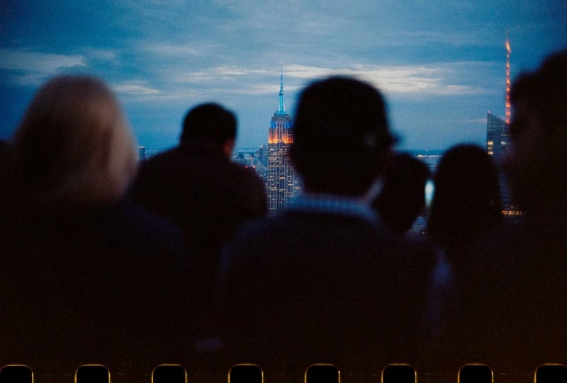 Caleb - sundown-in-the-city-a-group-of-people-at-an-outlook-from-a-tall ...